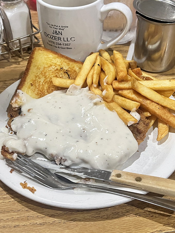 The chicken fried steak &ndash; where gravy isn't just a topping, it's a warm, peppery blanket tucking in a perfectly crispy cutlet.