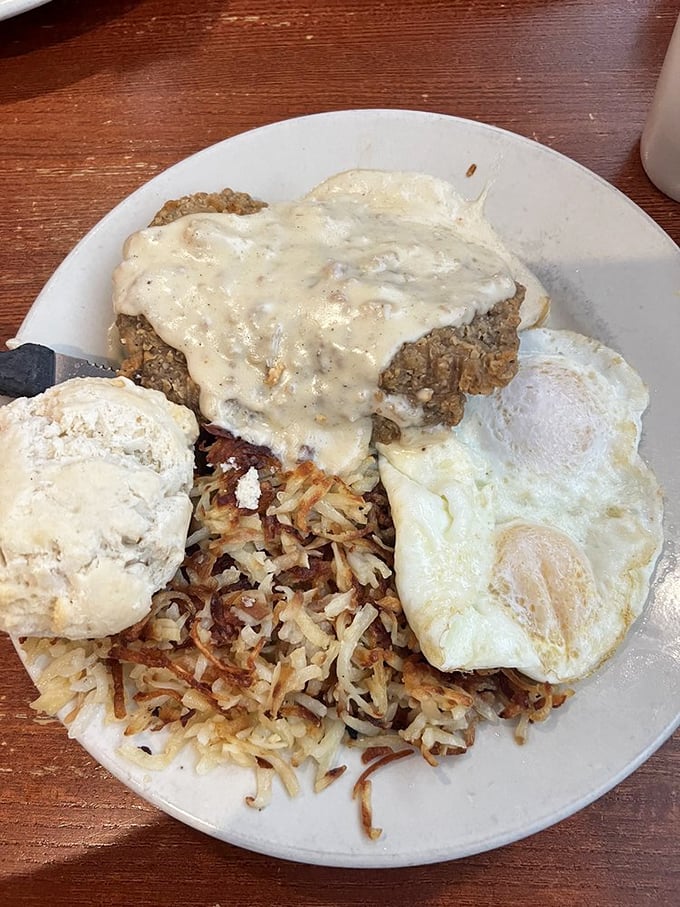 Chicken fried steak smothered in gravy with a side of hash browns that could make a potato farmer weep with pride.