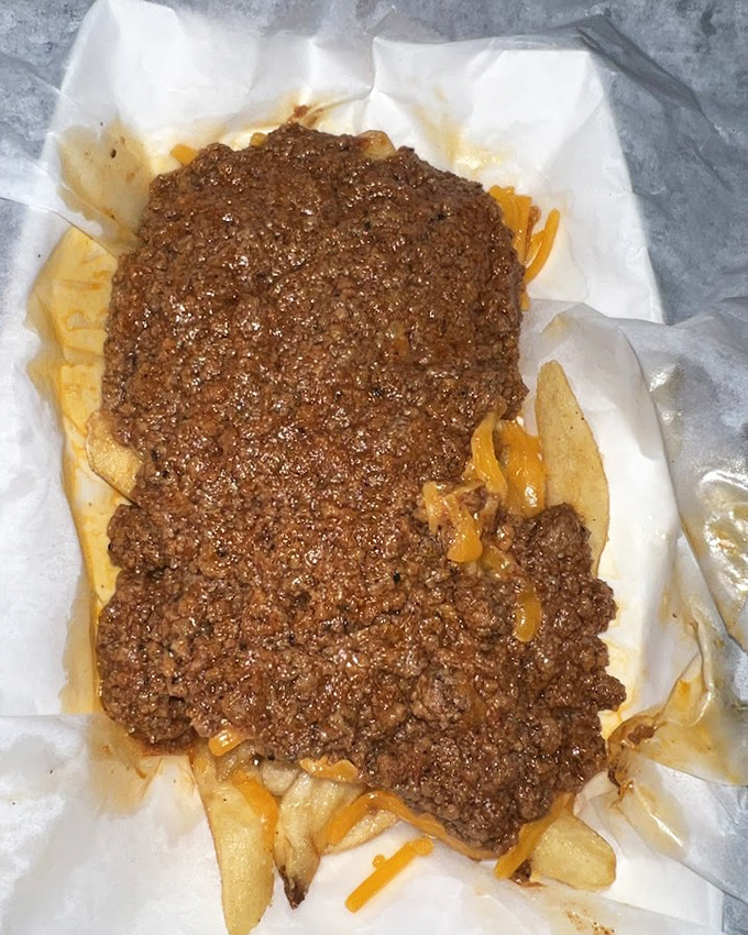 Chili cheese fries that don't mess around – a glorious mess of savory, cheesy, potato-y goodness that requires both a fork and absolutely zero shame.