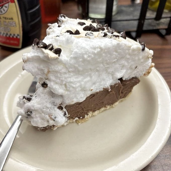 Mile-high chocolate pie with meringue that defies both gravity and restraint &ndash; this isn't dessert, it's performance art you can eat.