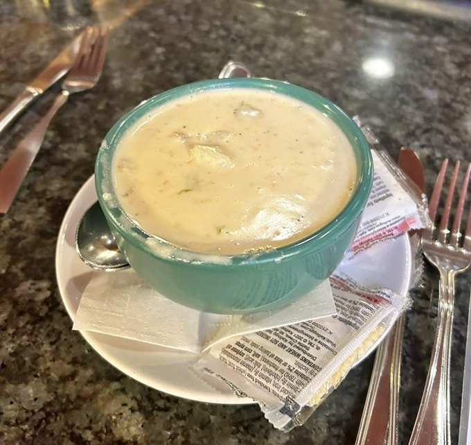 A bowl of clam chowder that could make a New Englander homesick, served in that distinctive turquoise bowl that says "comfort is coming."
