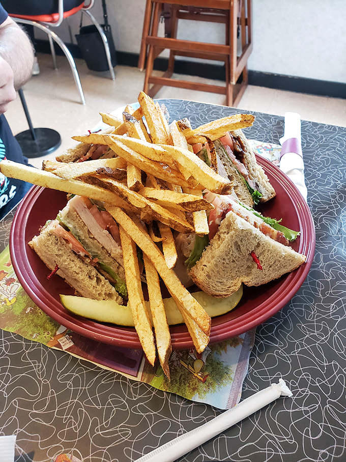 The club sandwich: architectural marvel of the diner world. Those perfectly golden fries aren't just sides&mdash;they're supporting actors deserving their own award.