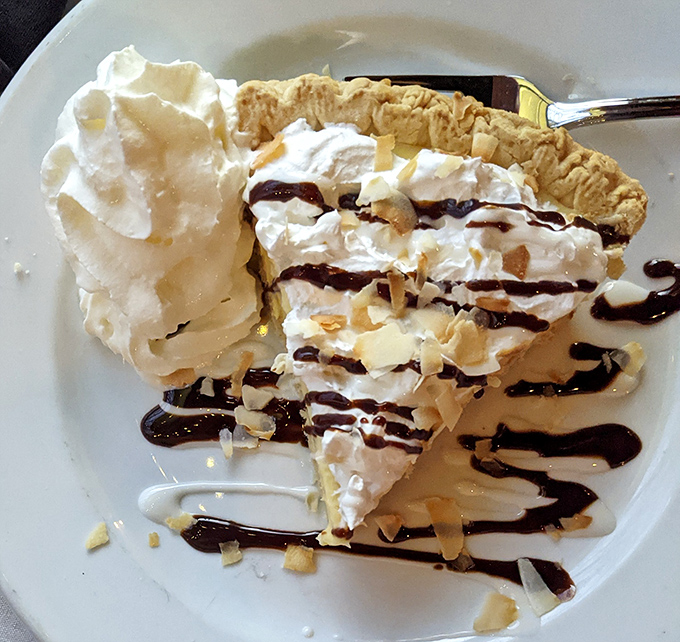 Coconut cream pie that doesn't just satisfy your sweet tooth—it throws a beach party for your taste buds with chocolate sauce waves.
