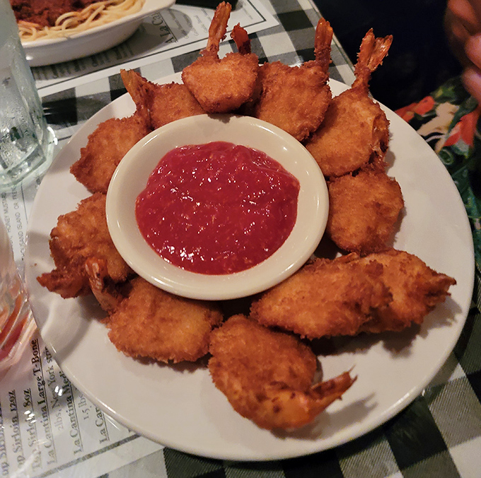 Golden-fried shrimp form a perfect circle around cocktail sauce &ndash; like a delicious clock counting down the moments until your next bite.