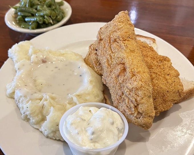 The fish arrives golden and crisp, with fries standing at attention. No pretentious foam or reduction here&mdash;just honest-to-goodness satisfaction on a white plate.