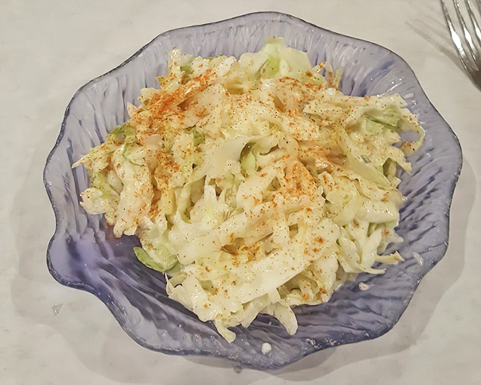 Coleslaw that doesn't know it's a side dish. This creamy, crunchy creation in its shell-shaped bowl deserves main character energy.