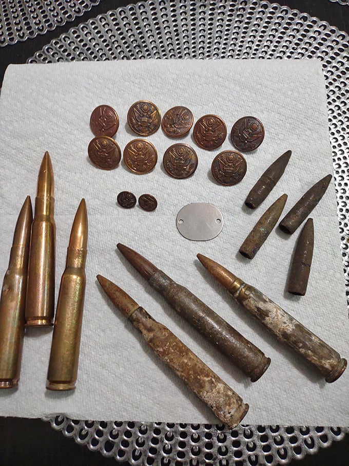 Military artifacts rest in solemn display, each bullet and button a tangible connection to the history that shaped our nation.