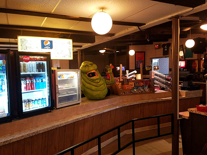 Slimer from Ghostbusters guards the snack counter, ensuring your popcorn comes with a side of '80s nostalgia and green ectoplasm jokes.