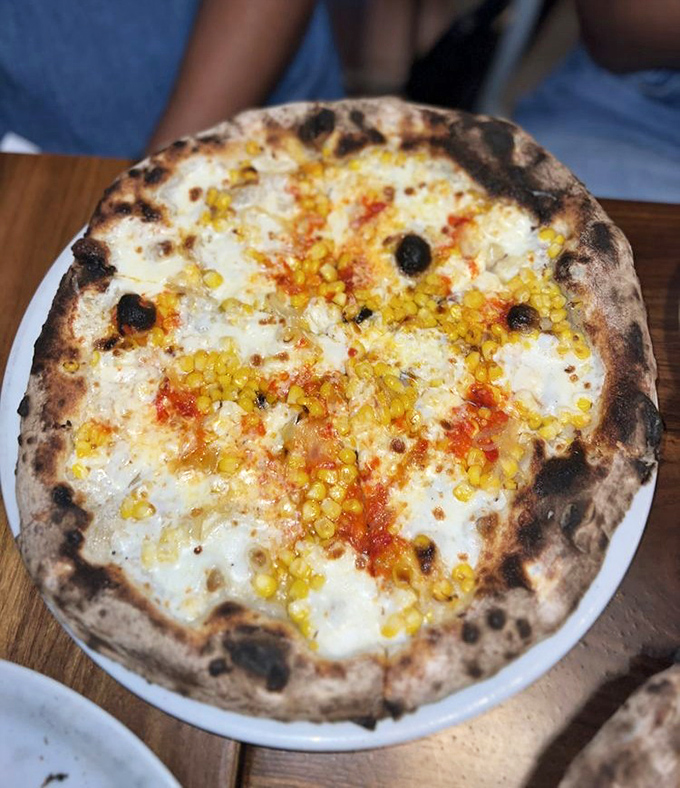 Summer on a plate &ndash; sweet corn and cheese meld into pizza perfection with just enough char to remind you this isn't some ordinary pie.