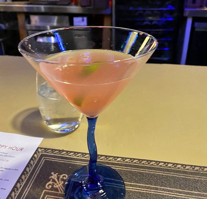 The cocktail glows with possibility in its blue-stemmed glass&mdash;like a sunset captured in liquid form, promising good decisions or interesting stories.