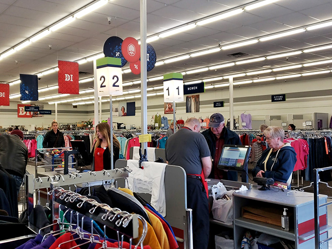 The checkout experience: where friendly staff tally your treasures while fellow bargain hunters compare their day's victories.