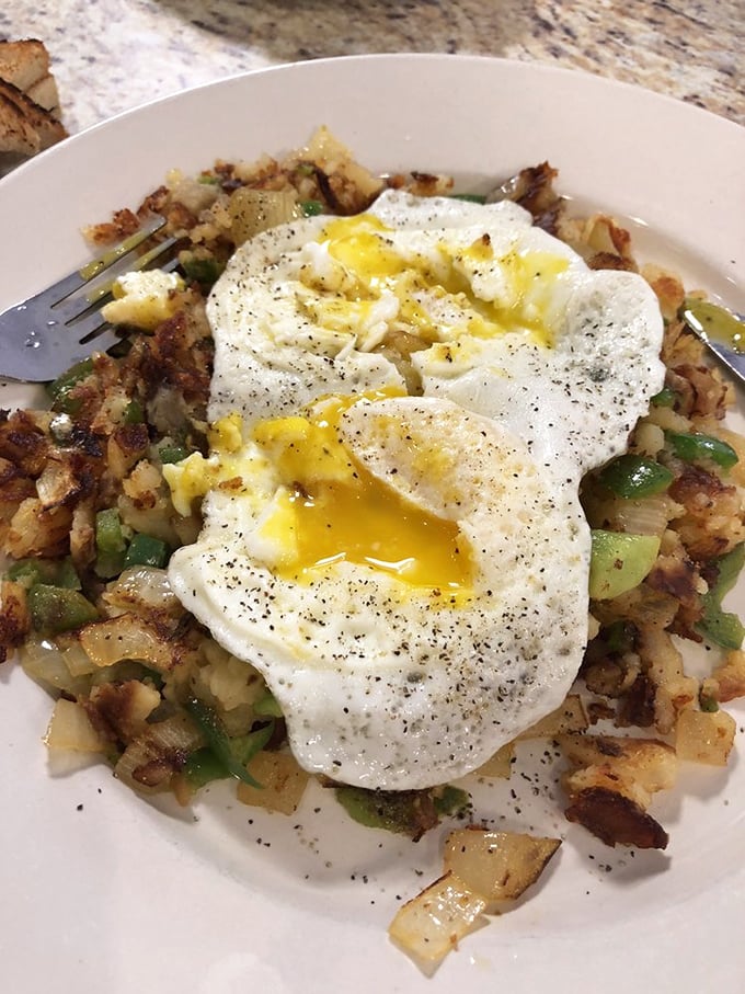 The perfect sunny-side-up egg crowns a throne of home fries&mdash;breakfast royalty that makes you wonder why we ever invented cereal.
