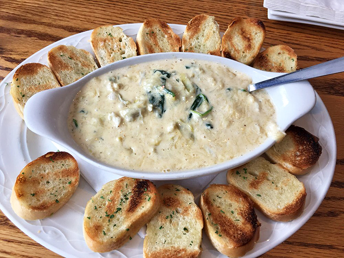 This crab and spinach dip surrounded by toasted bread is the diplomatic solution when you can't decide between appetizer and entr&eacute;e.