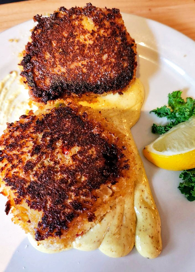 Crab cakes with a golden crust that could double as a sunset if sunsets were edible.