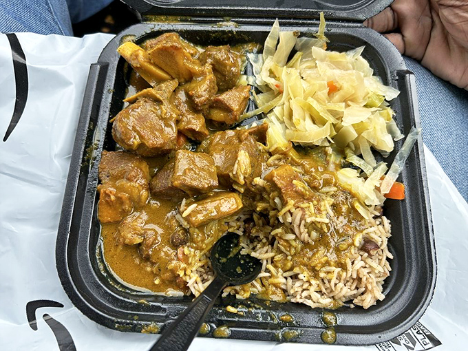 Curry goat with rice and cabbage&mdash;the kind of meal that makes you want to hug the chef and ask if they'd consider adoption.