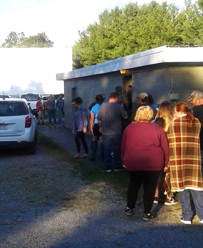 The concession stand line—where strangers become neighbors trading movie reviews and local gossip while waiting for their hot dogs and nachos.