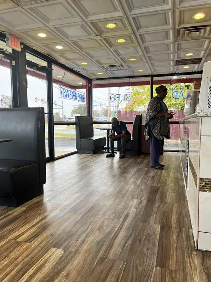 The modern diner experience: clean lines, comfortable booths, and the anticipation that builds while waiting for your number to be called.
