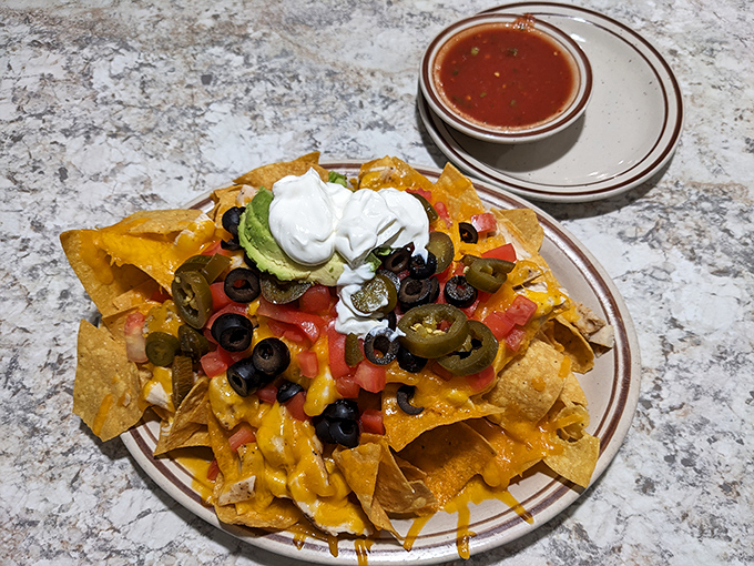 Nachos piled high with all the fixings &ndash; proof that Angie's knows comfort food extends well beyond the breakfast hours.
