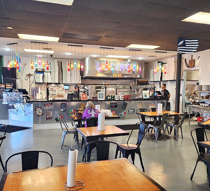 The counter view reveals the beating heart of Lucino's &ndash; where pizza dreams come to life under colorful pendant lights and watchful expertise.