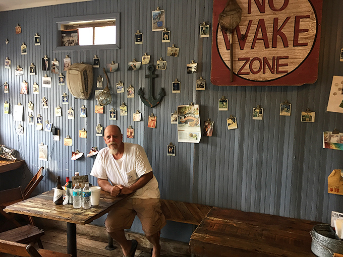 The blue walls adorned with fishing photos tell stories that don't need words. Every picture represents someone's "best day ever."