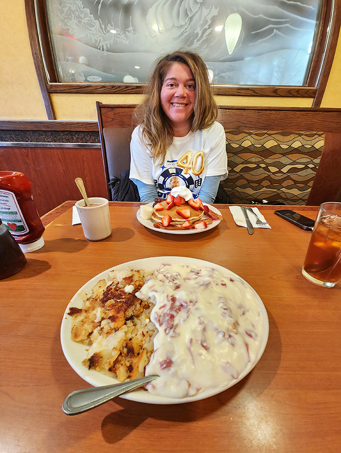 The image shows a diner patron enjoying what appears to be a celebratory meal. That smile says everything about the Shore Diner experience&mdash;pure food happiness.
