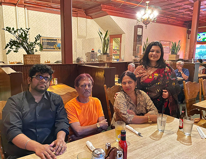 The dining room at Courier Cafe: where strangers become neighbors and neighbors become friends over plates of comfort food that needs no translation.