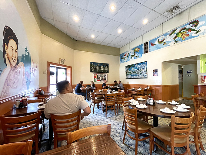 The dining room hums with the satisfied murmurs of patrons. That mural isn't just decoration&mdash;it's watching to make sure you order enough to share.