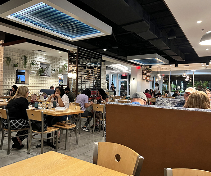 Even on busy nights, Agave Azul's dining room buzzes with energy as patrons dive into authentic Mexican cuisine under the restaurant's signature blue lighting.