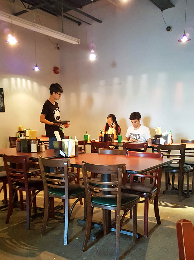 The dining room hums with the universal language of good eating—heads bowed over steaming bowls, the occasional nod of approval, spoons diving back for more.