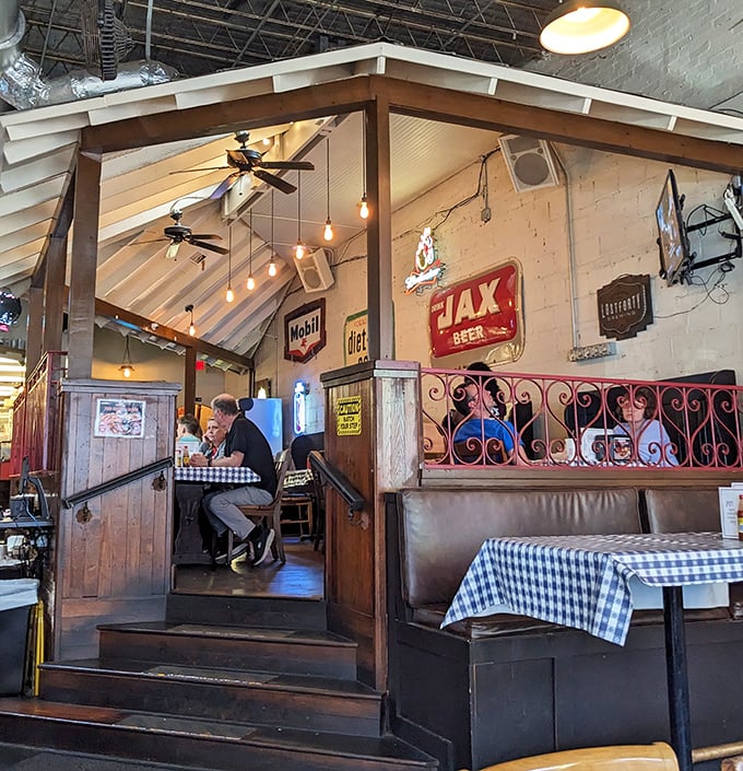 The elevated dining area feels like you've been invited to the cool kids' table. Vintage beer signs silently approve of your excellent life choices.