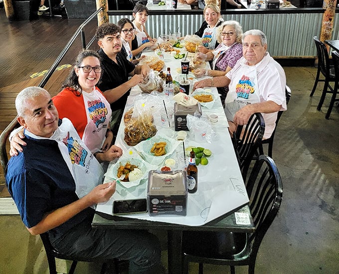 Three generations sharing butcher paper piled with seafood proves some meals create memories that last longer than the bibs do.