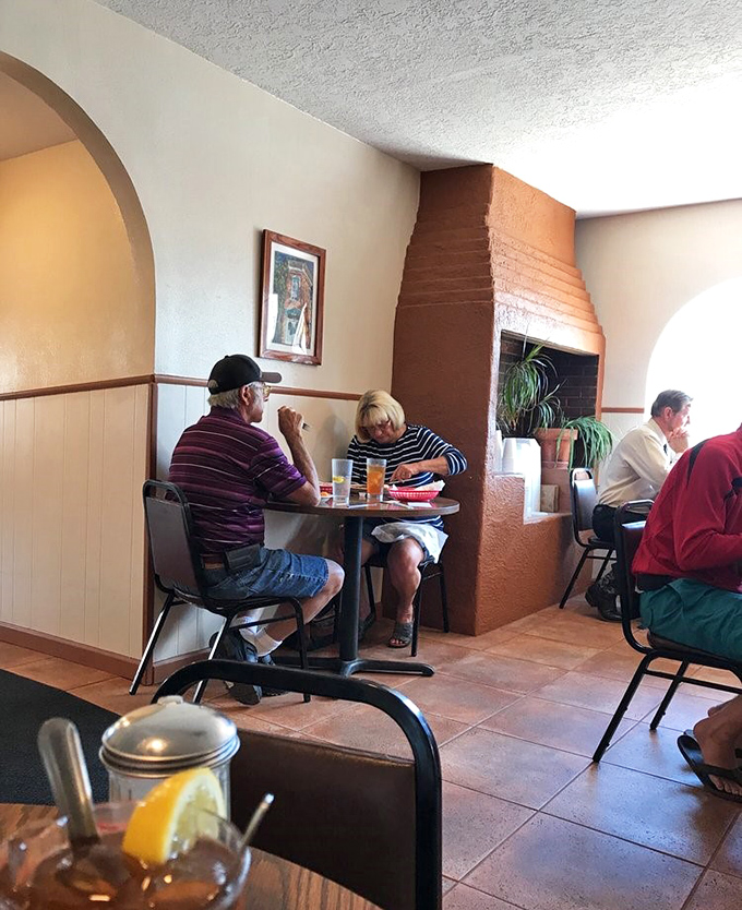 The dining room hums with the satisfied murmurs of locals who've been coming here longer than most restaurants have been open.