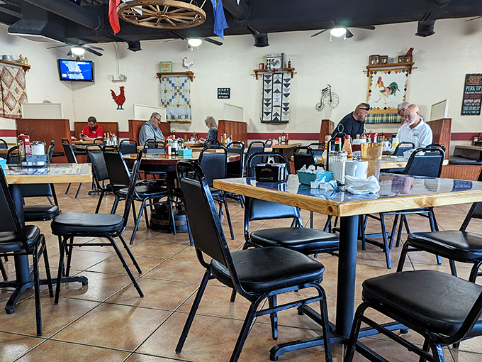 Regulars gather in the dining room where conversations flow as freely as the coffee, under the watchful eye of country-themed wall decorations.