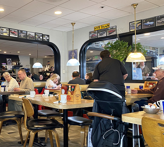 The dining room hums with conversation and clinking silverware – a community gathering place where strangers become neighbors over shared maple syrup.