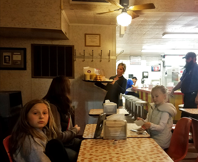 The dining area captures families making memories over crispy chicken and creamy sides, proving some traditions are worth preserving.