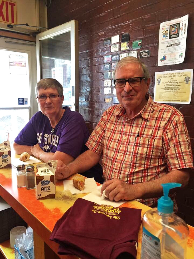 The counter at Squeeze-In: where strangers become friends united by their appreciation for perfectly crafted hot dogs.