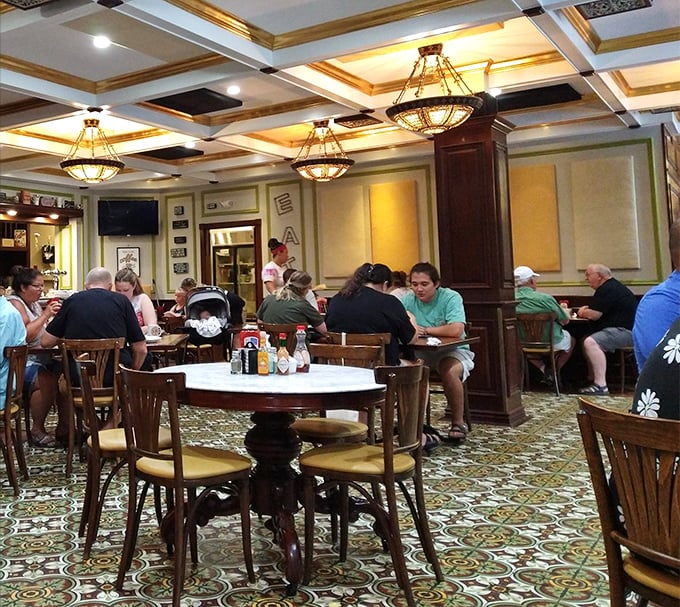 The dining room hums with conversation and clinking forks – the soundtrack of a Nebraska morning ritual playing out beneath elegant chandeliers.