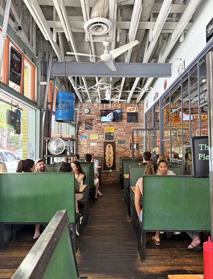 Green booths create cozy neighborhoods within the restaurant, while exposed brick and vintage signs tell stories you'll want to hear between bites.