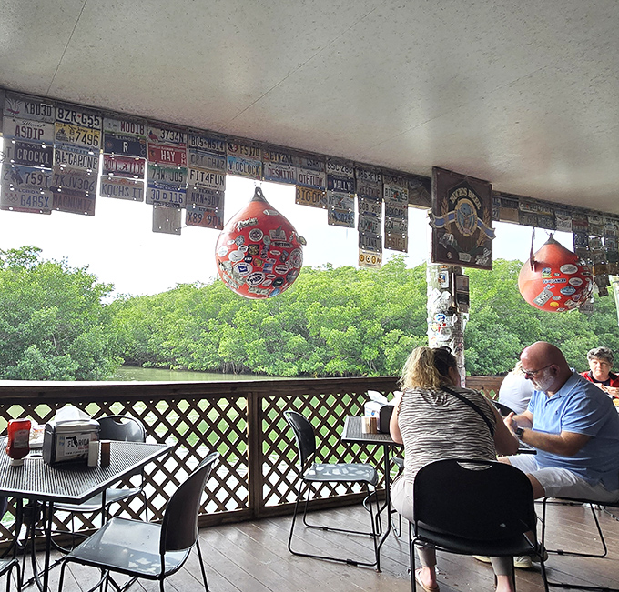 Diners enjoying their meals with a backdrop of mangroves, living their best waterfront life right now.