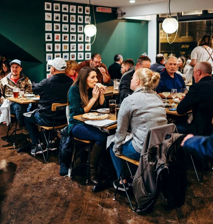 The dinner crowd settling in for the evening, each table its own little universe of culinary contentment.