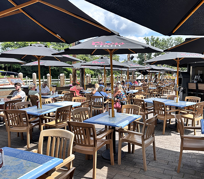 The outdoor dining area transforms summer into a tangible experience&mdash;umbrellas, lake views, and the gentle clinking of glasses creating Minnesota's perfect afternoon soundtrack.