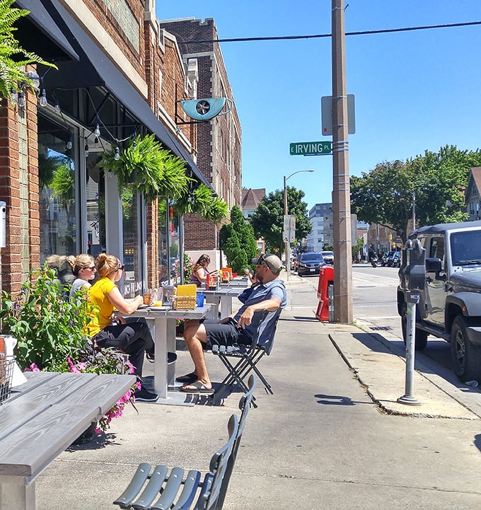 Summer in Milwaukee means sidewalk dining, where locals gather to enjoy both the food and the neighborhood parade passing by.
