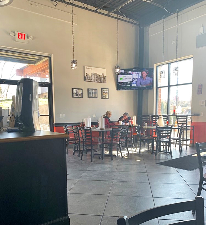 The dining area balances casual comfort with modern simplicity. High ceilings and natural light create a space where the only thing better than the ambiance is the chicken.