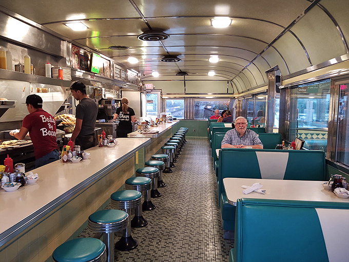 The long, narrow dining car design creates the perfect balance of privacy and community. Every seat offers a view of the culinary choreography behind the counter.