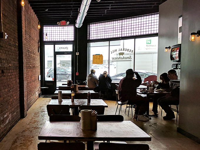 The universal posture of barbecue enjoyment: leaning forward, fully engaged, conversation paused. Good food creates its own atmosphere.
