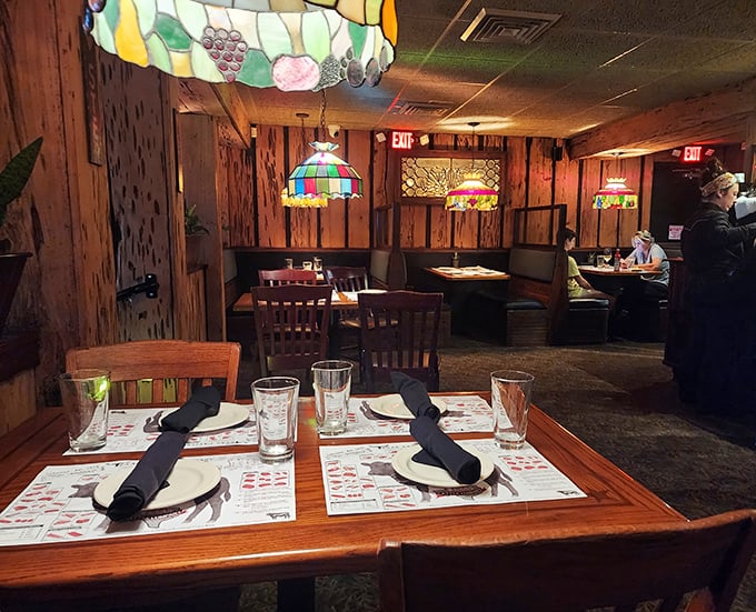 The dining room feels like a secret clubhouse for steak lovers, where Tiffany-style lamps cast a glow that makes everyone look like they've made excellent life choices.