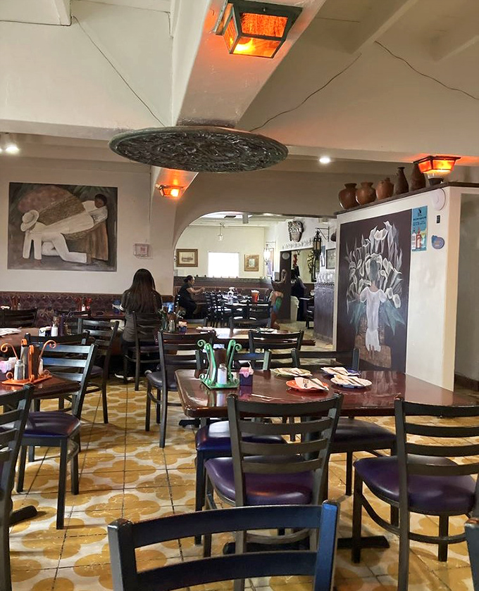 The dining room hums with conversation and satisfaction, artwork watching over patrons like old friends at a reunion.