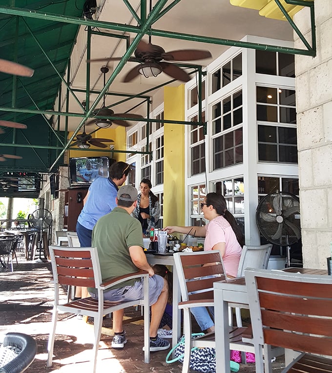 The outdoor seating area transforms ordinary meals into al fresco adventures. Those ceiling fans ensure Florida's heat never interferes with your dining pleasure.