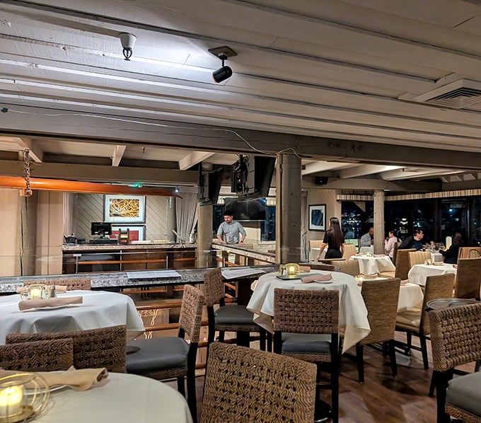 The dining room buzzes with happy conversations and the clinking of glasses, where good food brings people together over water views.