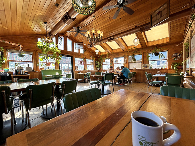 Sunlight streams through windows into this wood-paneled sanctuary where coffee steams and breakfast dreams come true.